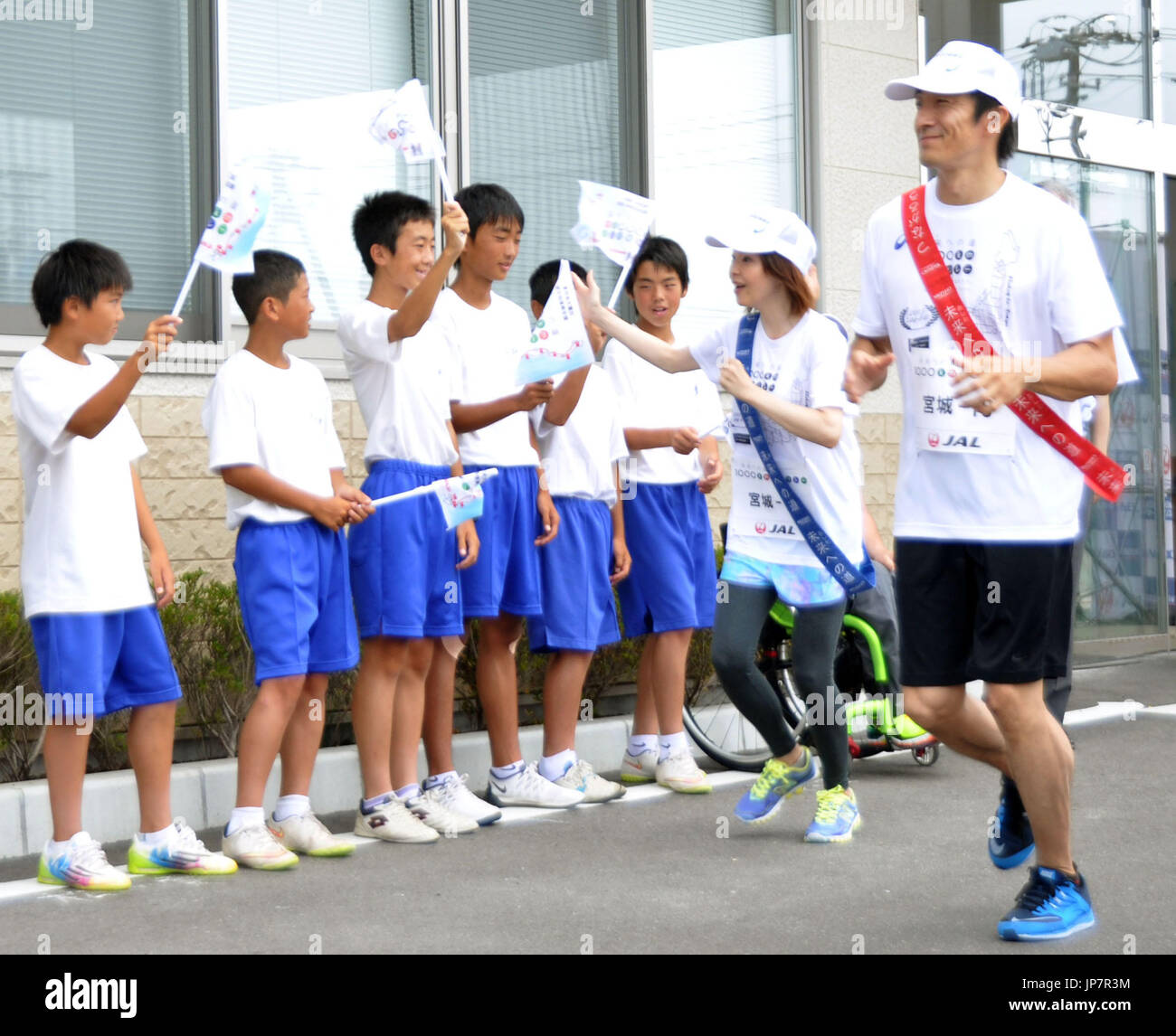 Retired Japanese Olympic athletes Nobuharu Asahara (far R) and Masako ...