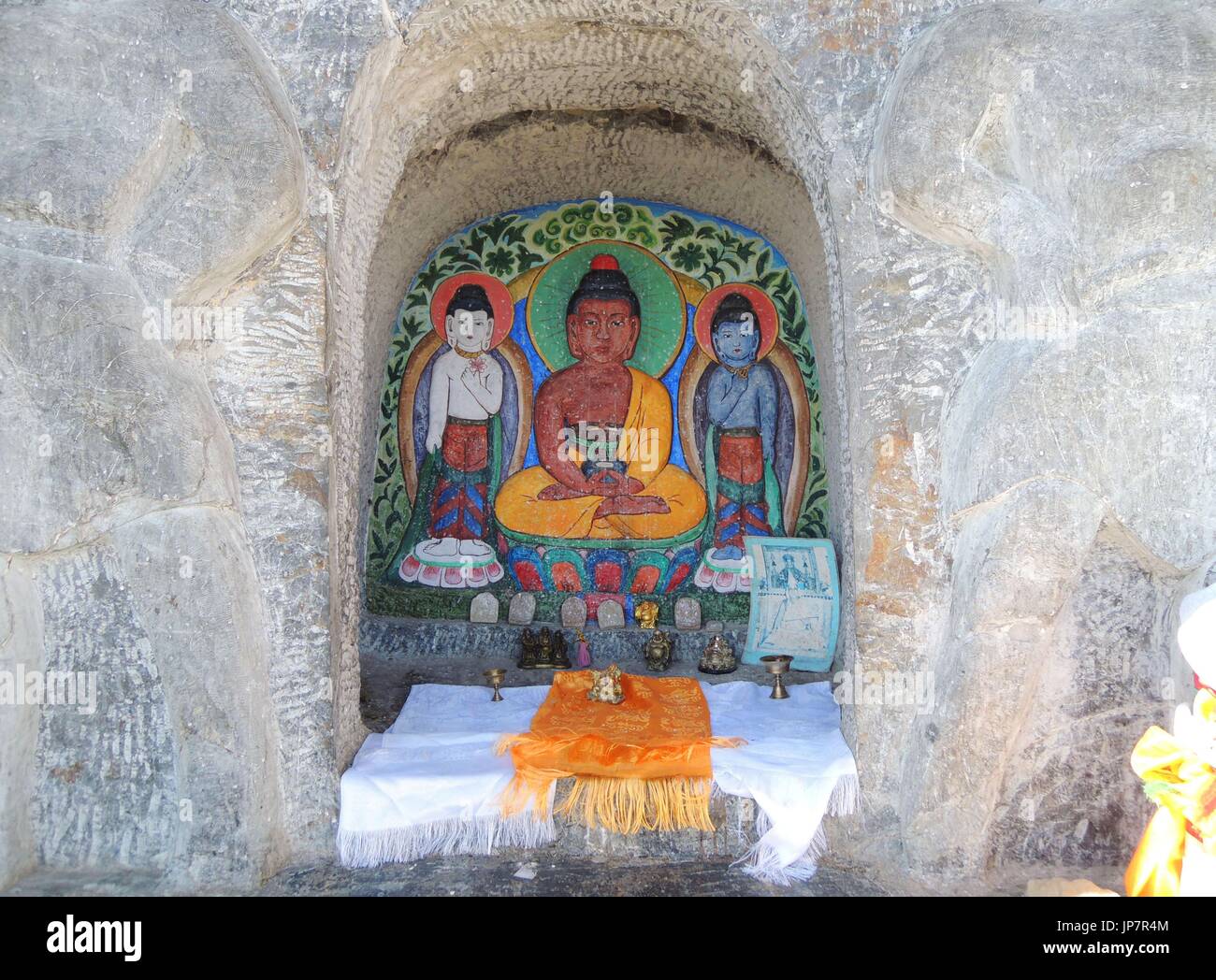 A relocated stone Buddha sculpture and its cave in Tyva, south-central ...