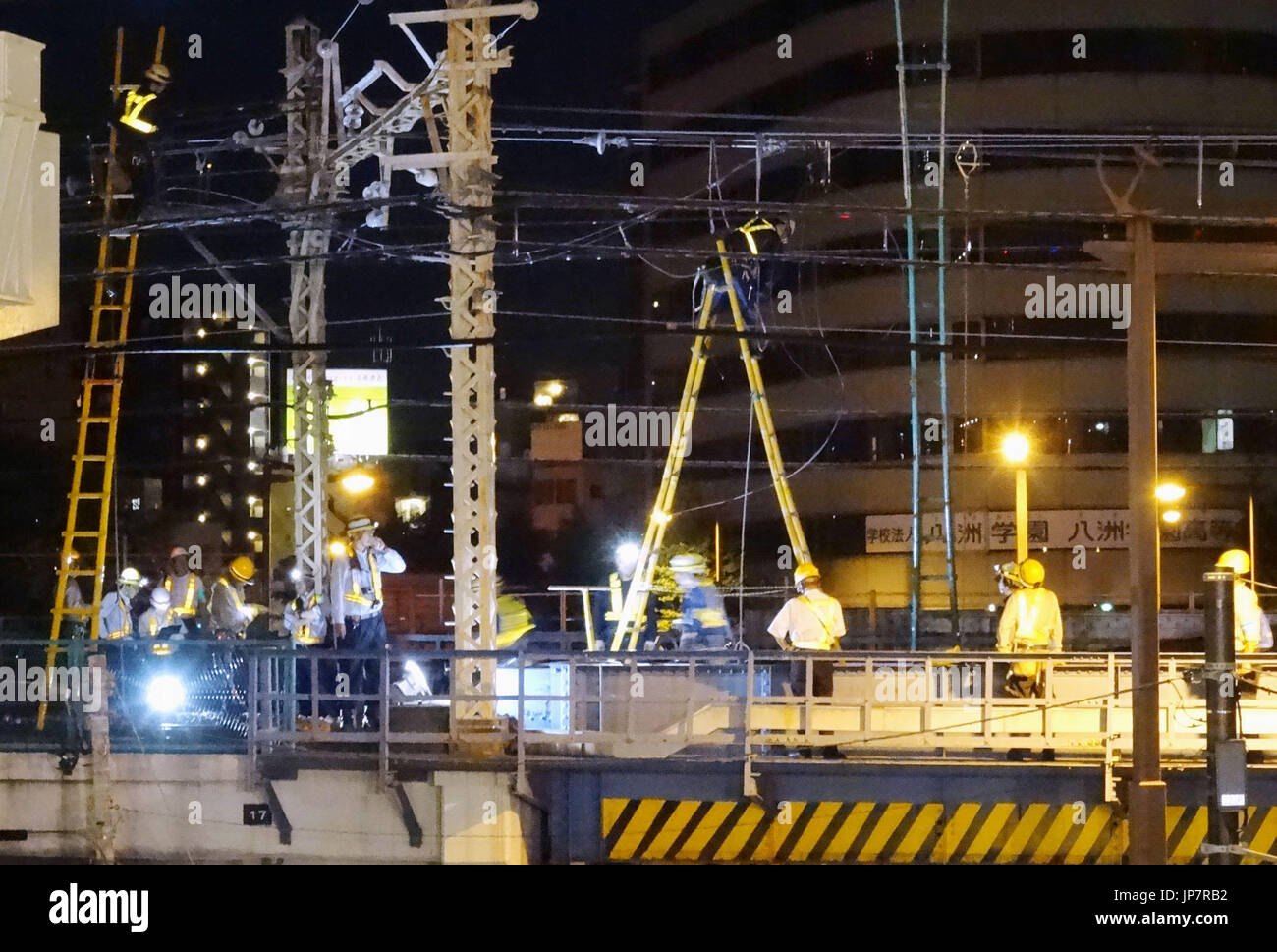 Railway workers repair a broken overhead cable in Yokohama on the JR ...