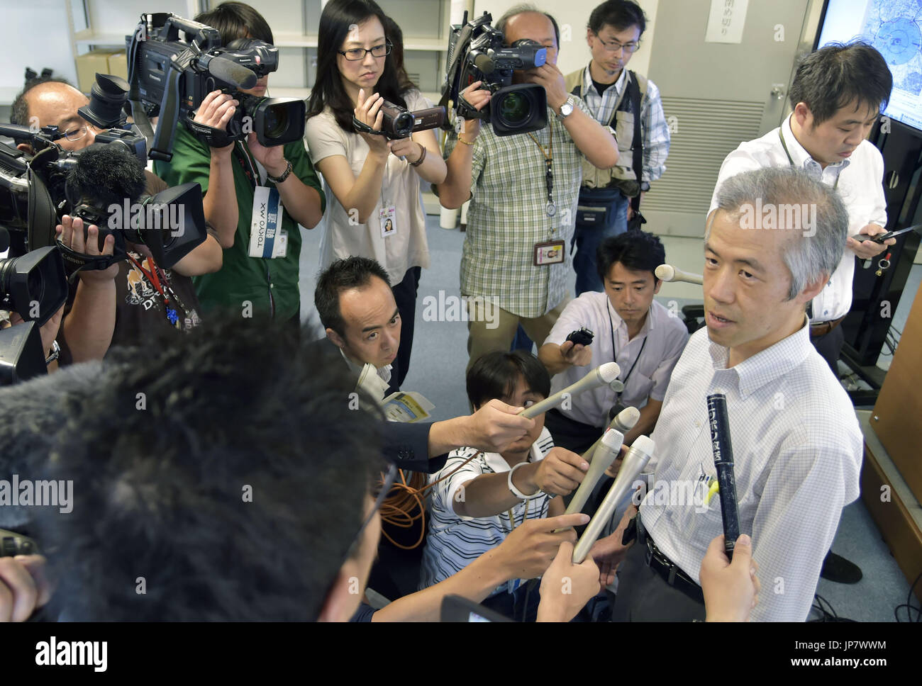 A Japan Meteorological Agency official speaks to reporters in Tokyo on ...