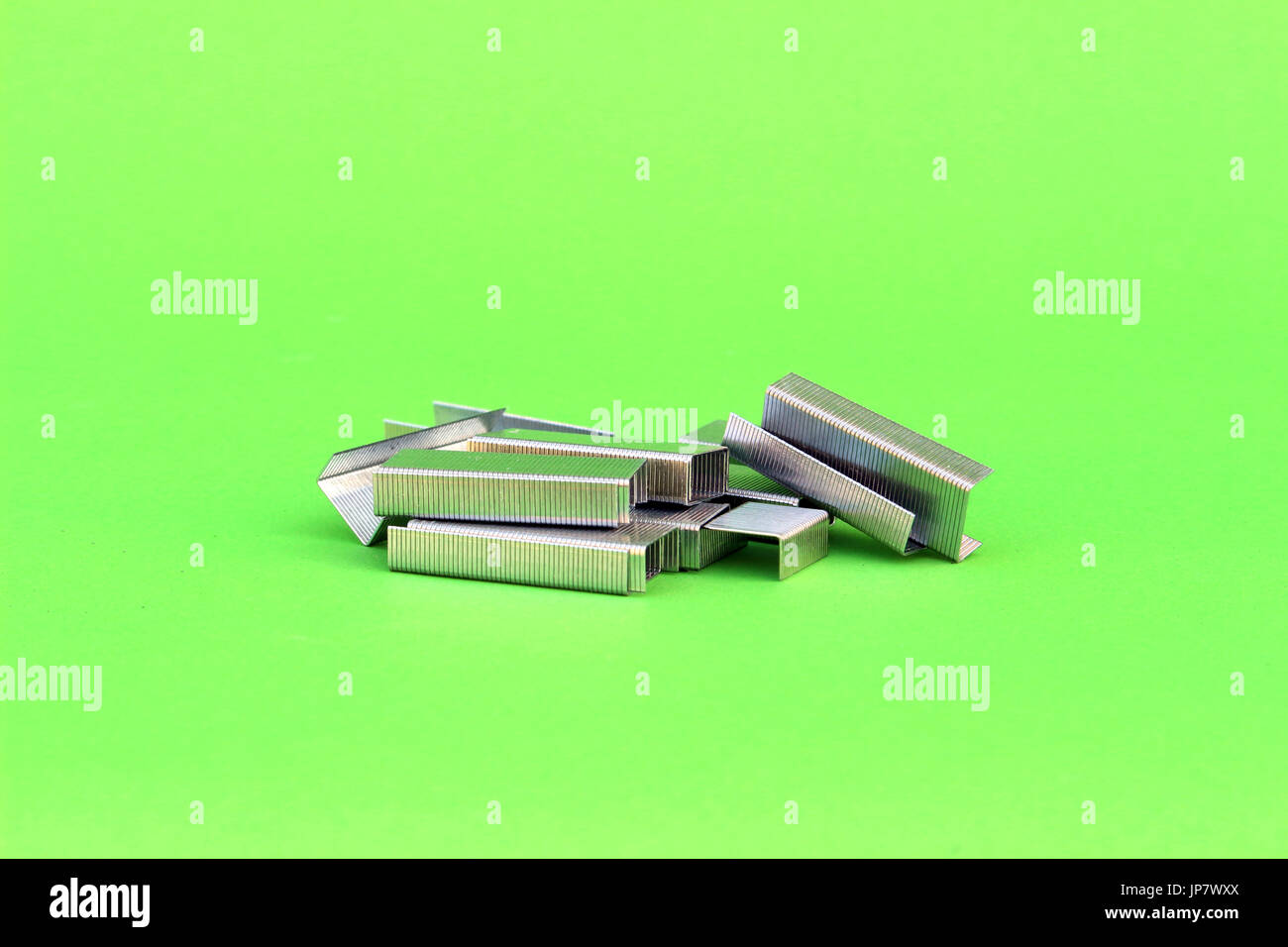 staples on isolated green Stock Photo - Alamy