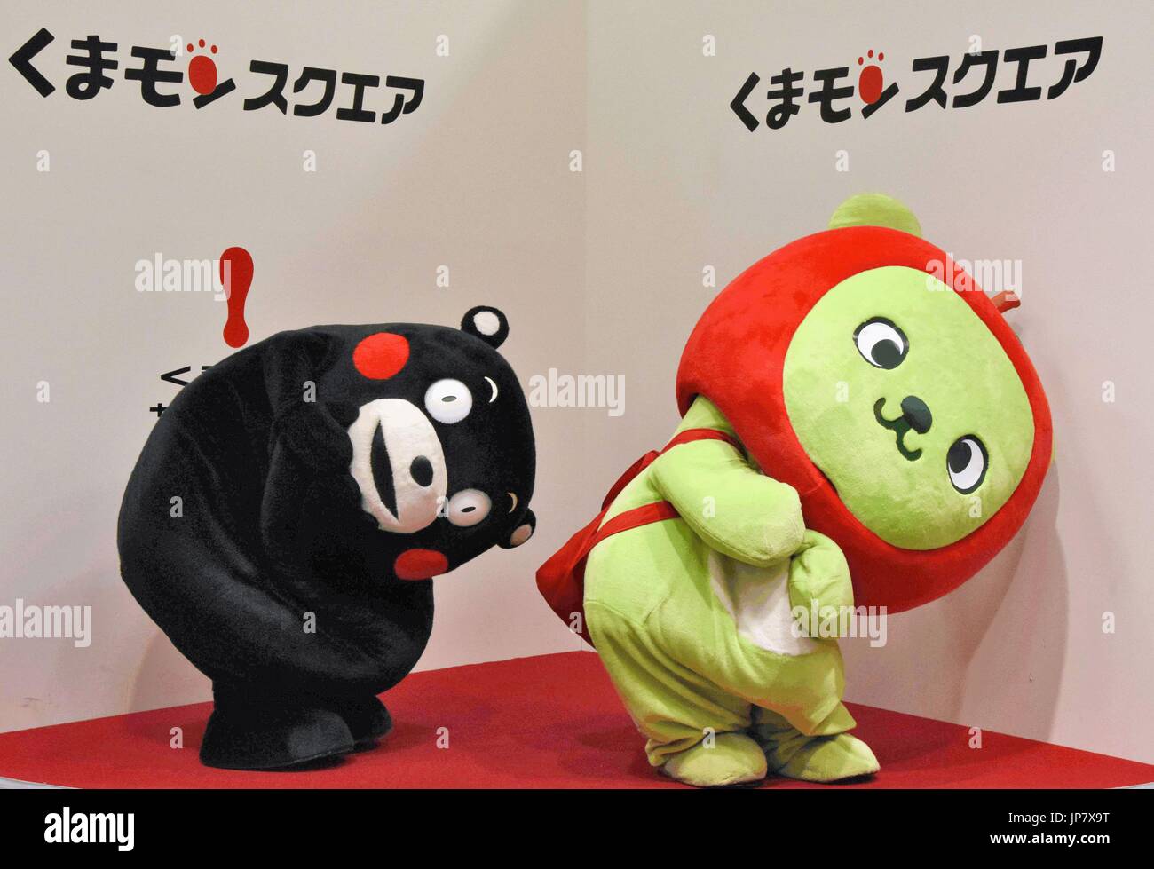 Black bear mascot Kumamon (L) and apple-bear mascot Arukuma dance at a ...