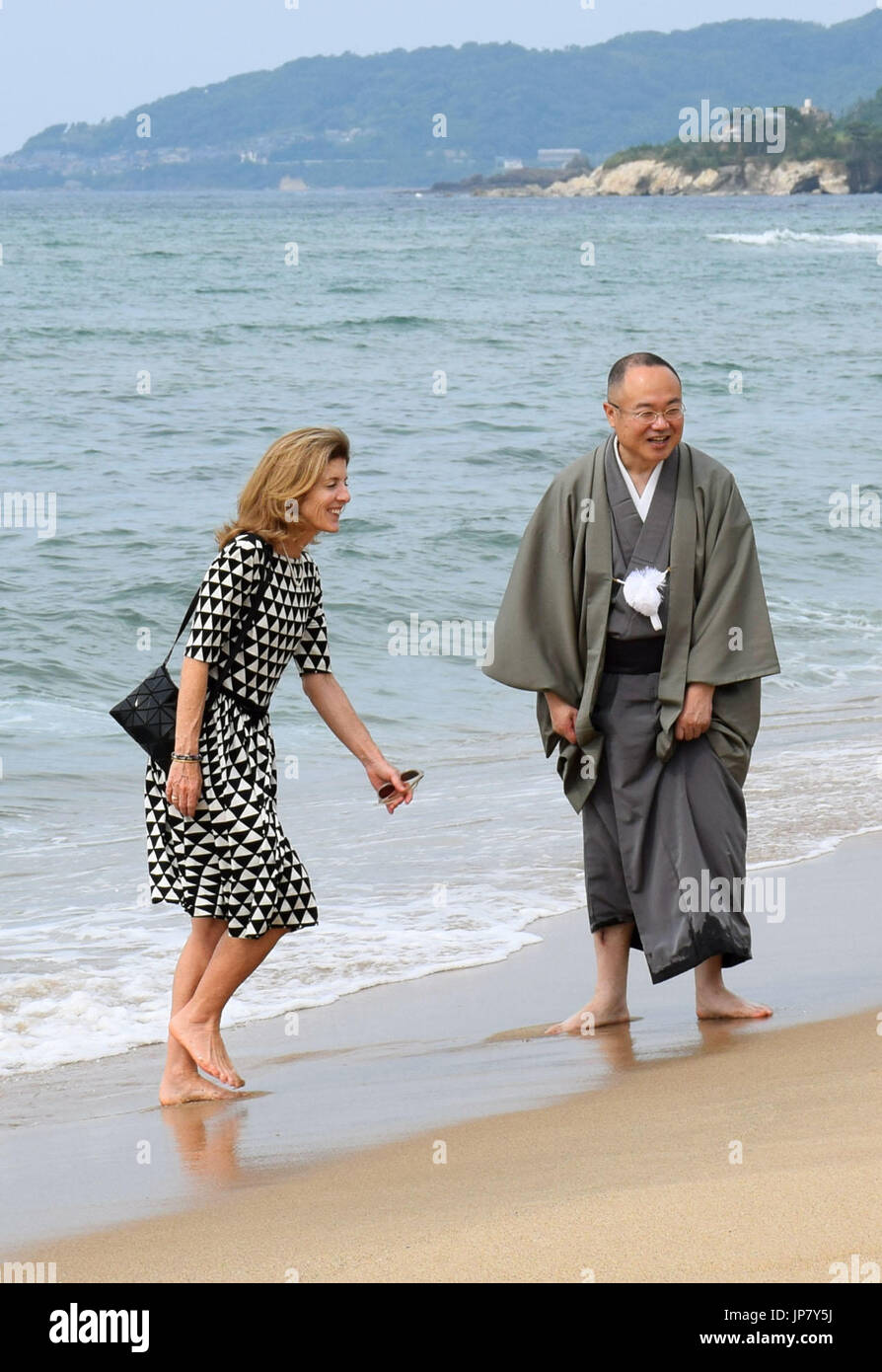 U.S. Ambassador to Japan Caroline Kennedy (L), walks barefoot on ...