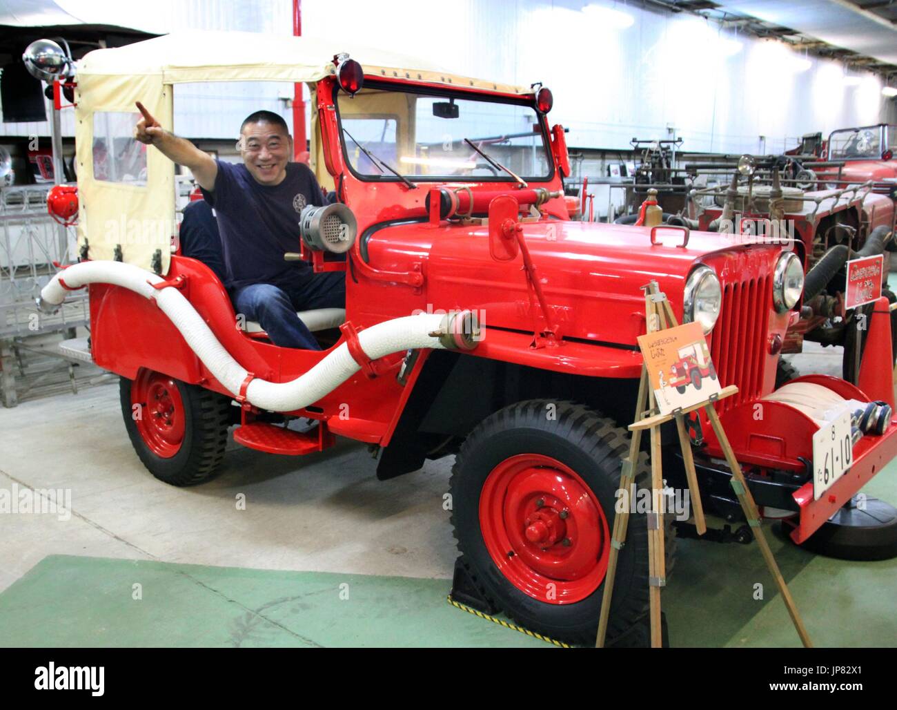 Yasuyuki Suzuki sits in a fire engine in Onjuku, Chiba Prefecture ...