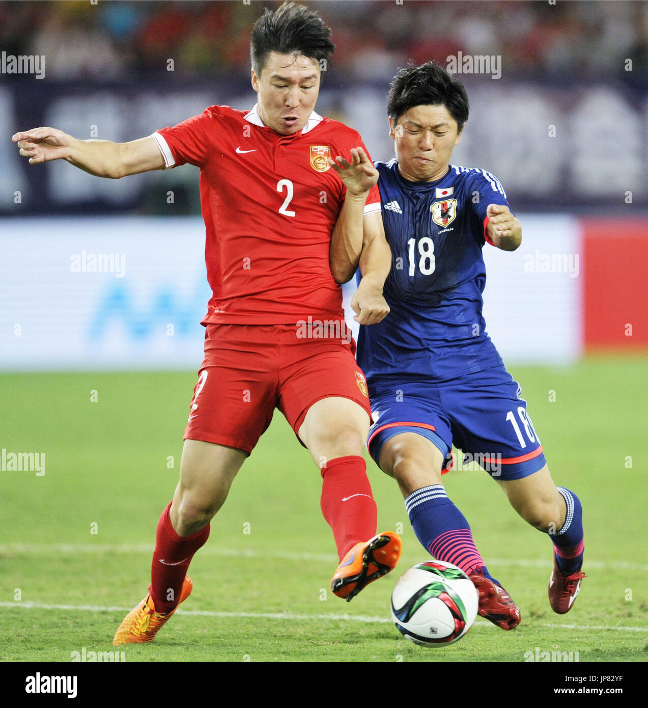 China's Ren Hang (L) and Yuki Muto of Japan tussle for the ball during ...