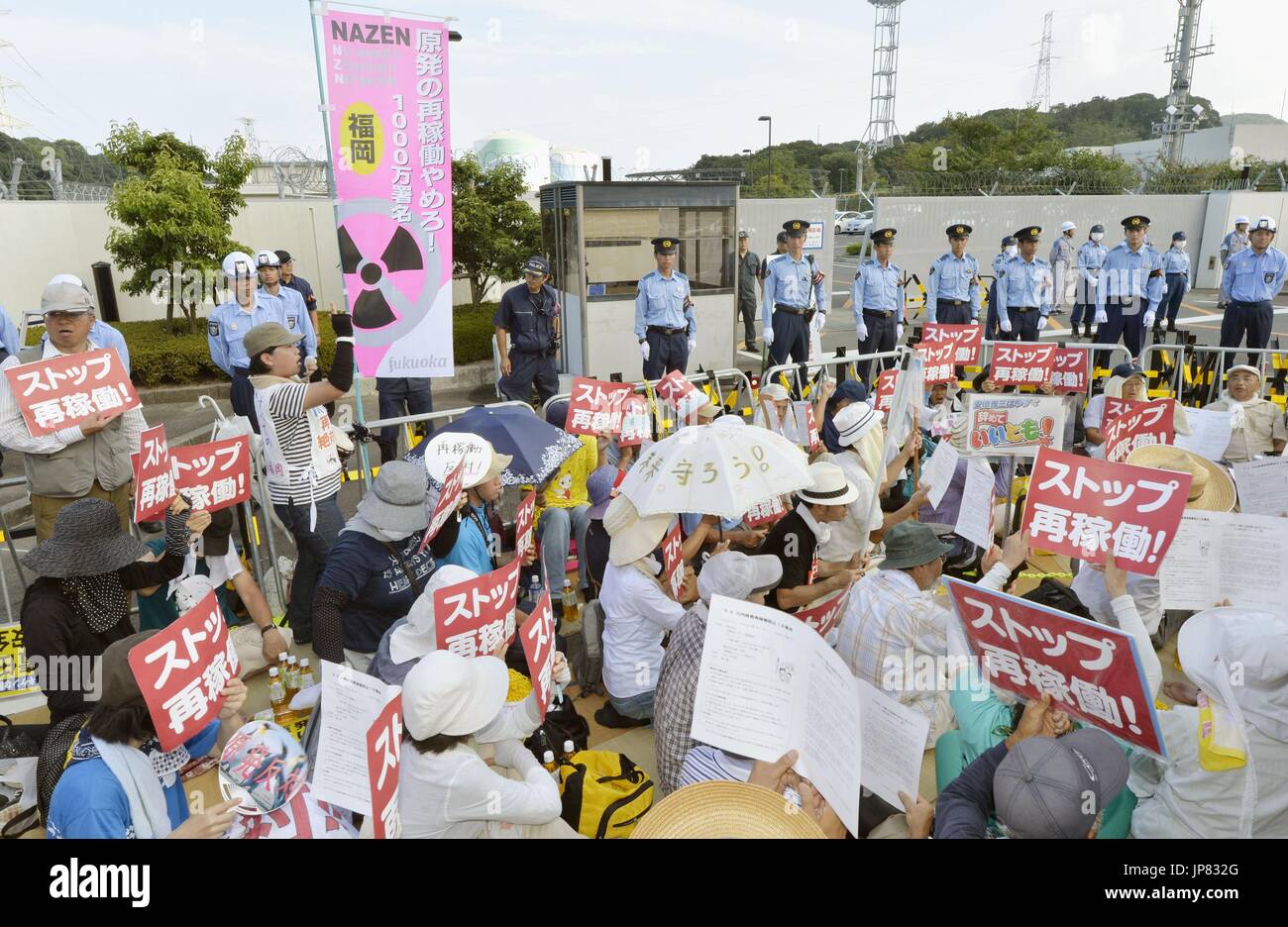 People stage a sit-in in front of Kyushu Electric Power Co.'s Sendai ...