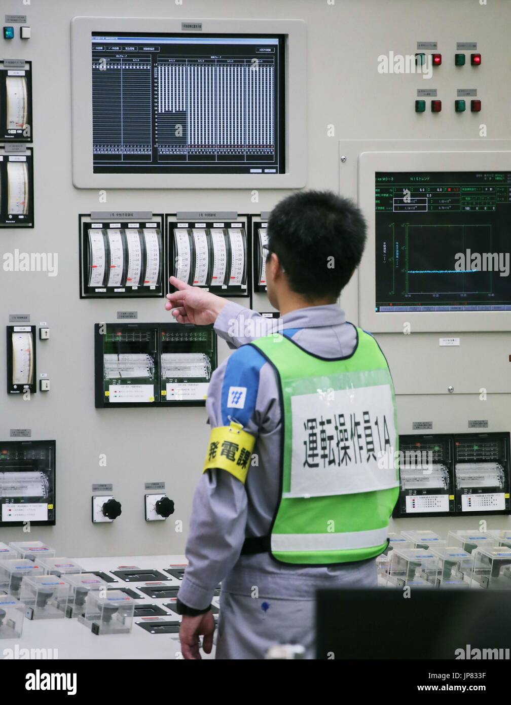 A worker in the main control room of Kyushu Electric Power Co.'s Sendai ...