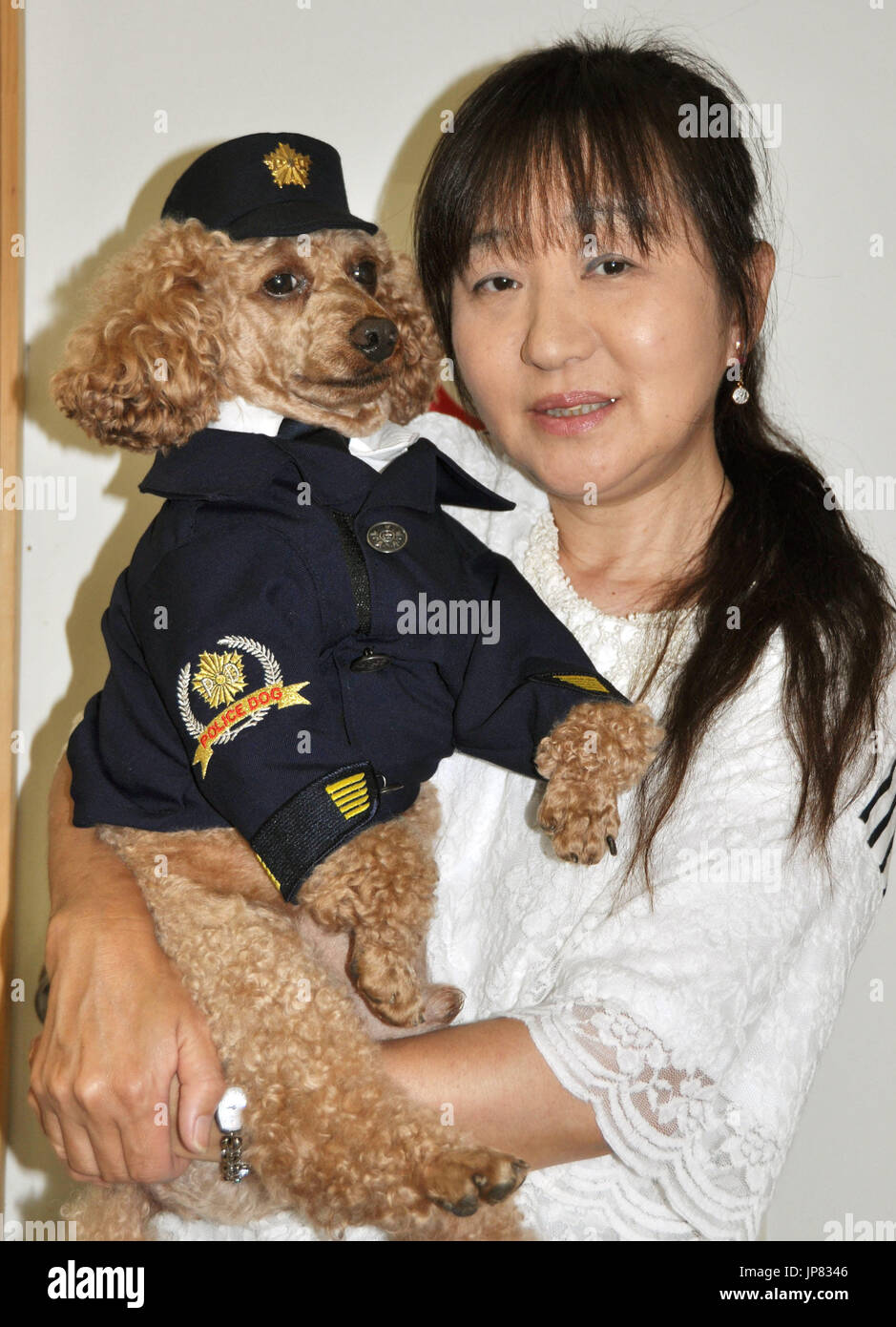 "Pocky," a 5-year-old toy poodle, and his owner Taeko Shibata pose in ...