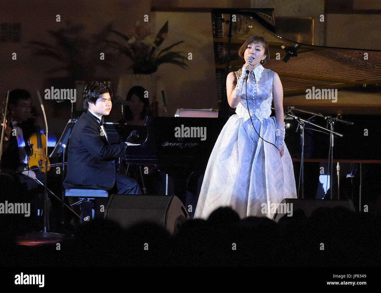 Blind pianist Nobuyuki Tsujii (L) accompanies singer Ayaka Hirahara at ...