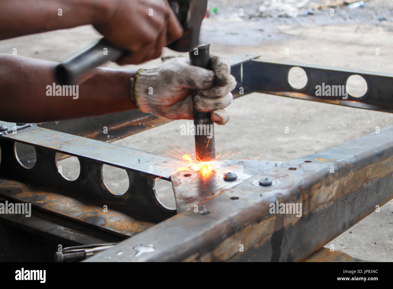 Hammering glowing steel - to strike while the iron is hot Stock Photo ...