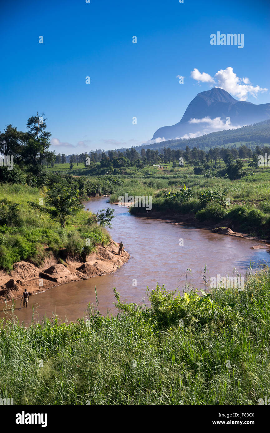 Man getting sand out of a river Stock Photo - Alamy