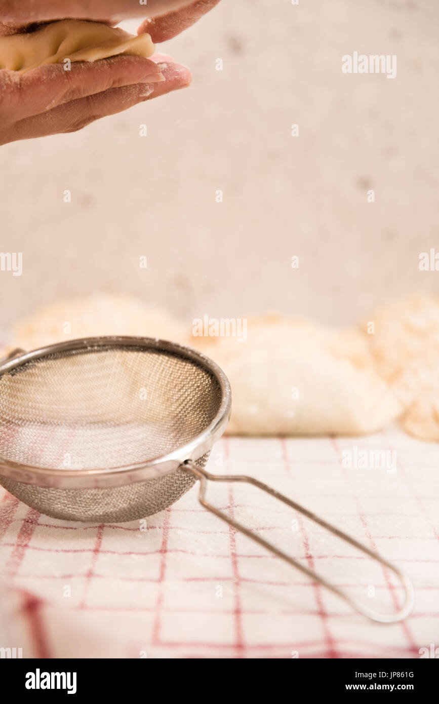 Strainer, Hands and Dumpling: Homemade Dim Sum preparing at Home Stock ...