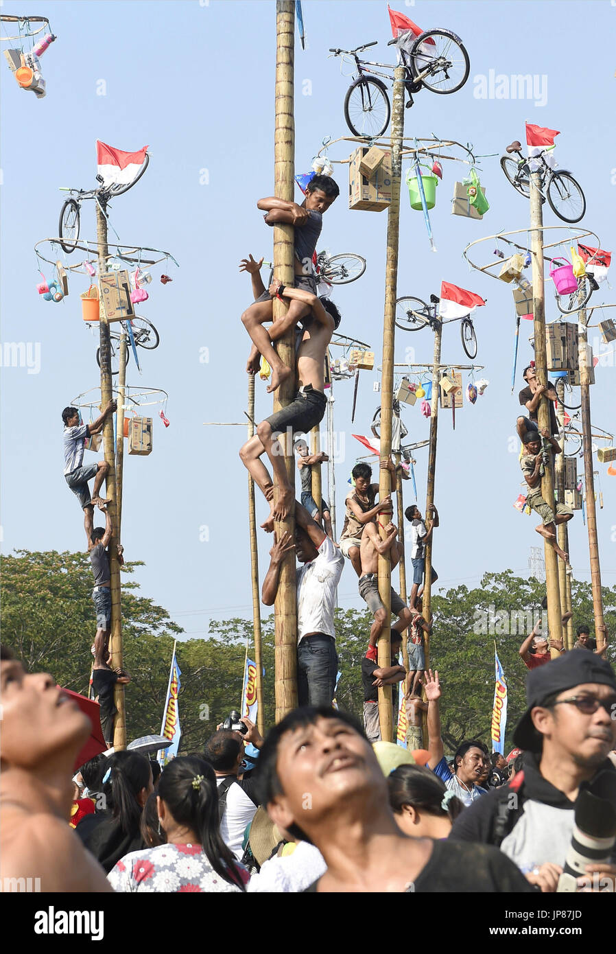 Panjat pinang, a team competition to climb slippery poles, is held in ...