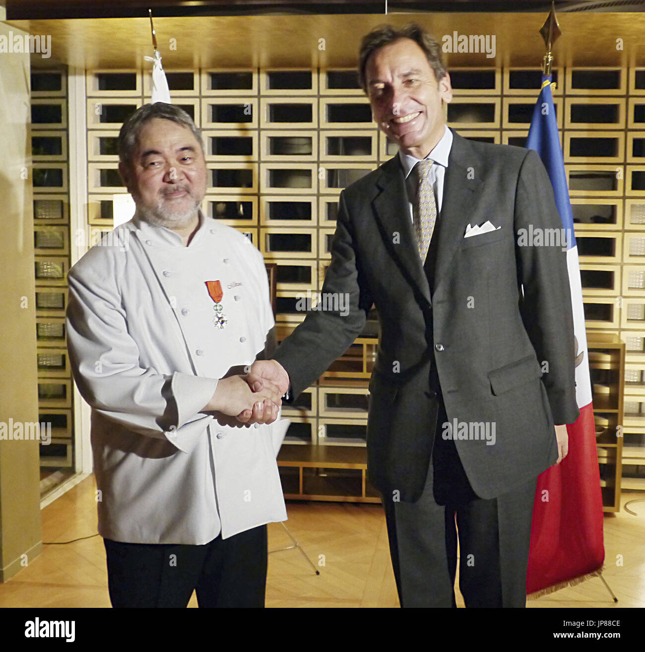 French cuisine chef Kiyomi Mikuni (L) shakes hands with French ...