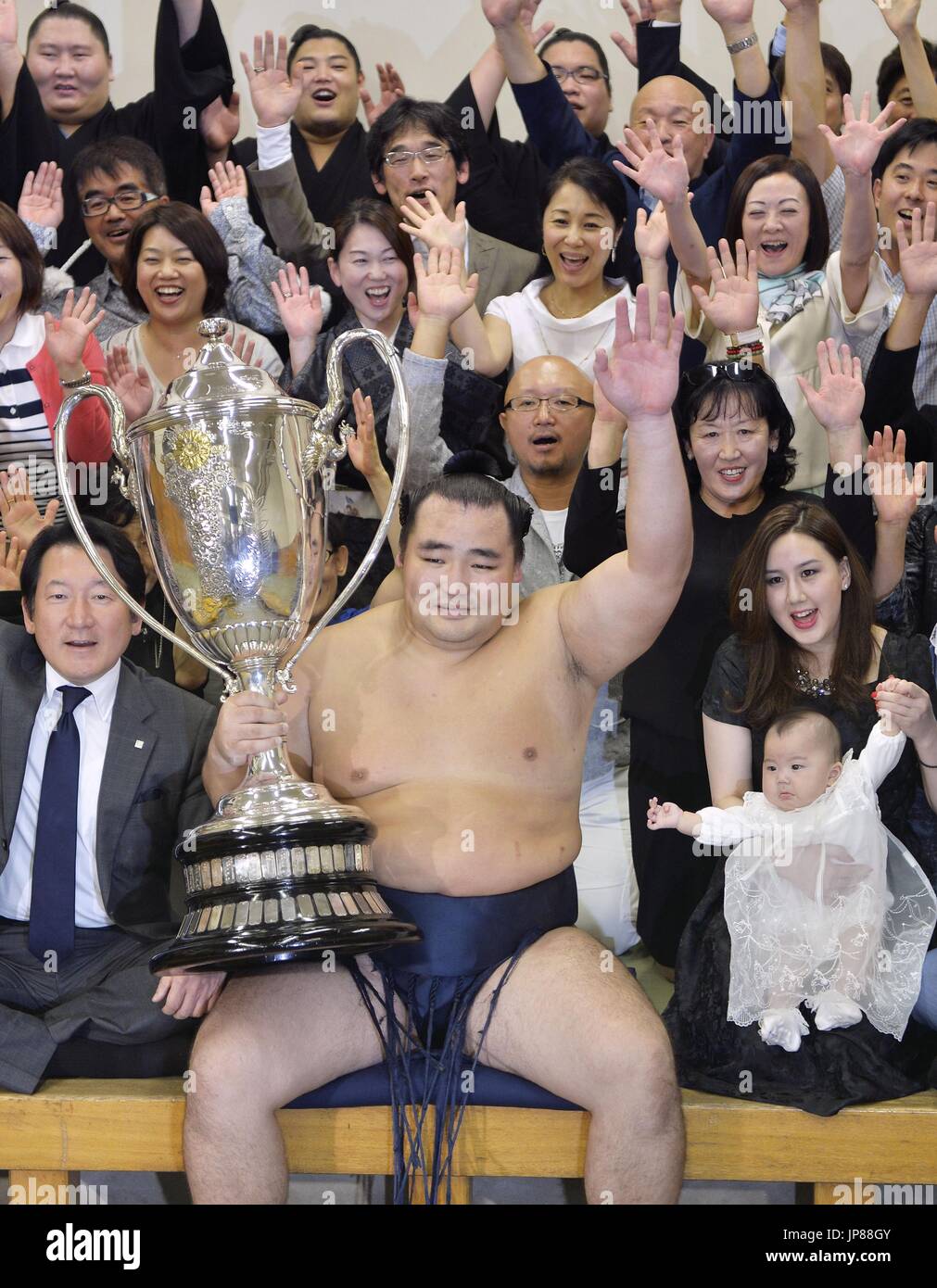 Mongolian yokozuna (grand champion) Kakuryu, surrounded by his ...