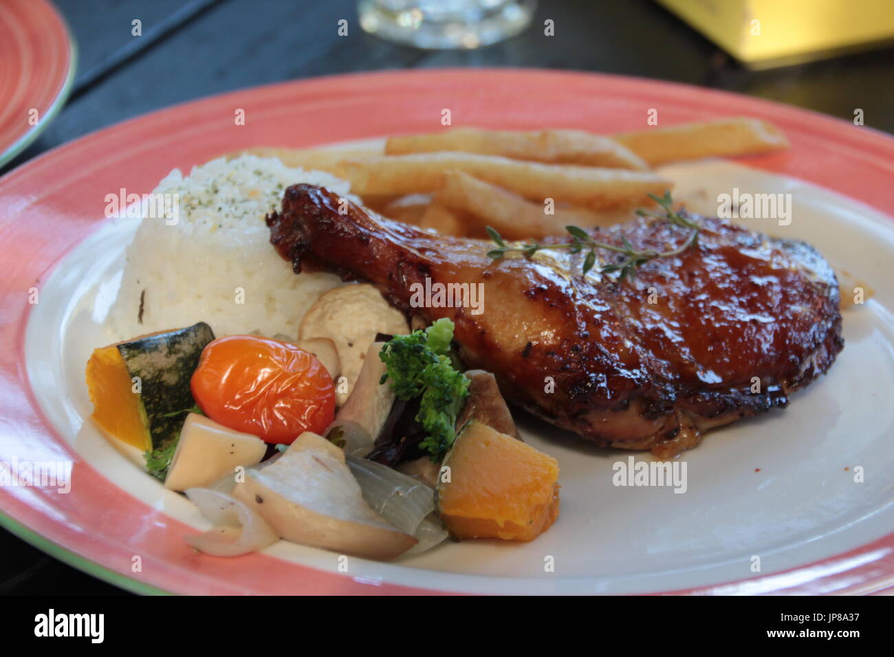 chicken rice plate garnish with fries Stock Photo - Alamy