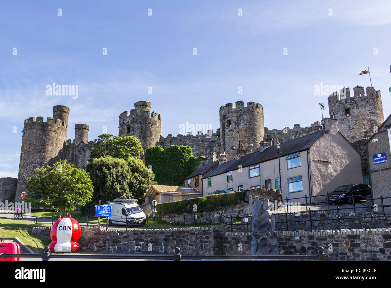 View of Conwy Castle from the Harbour, with a row of small cottages in ...