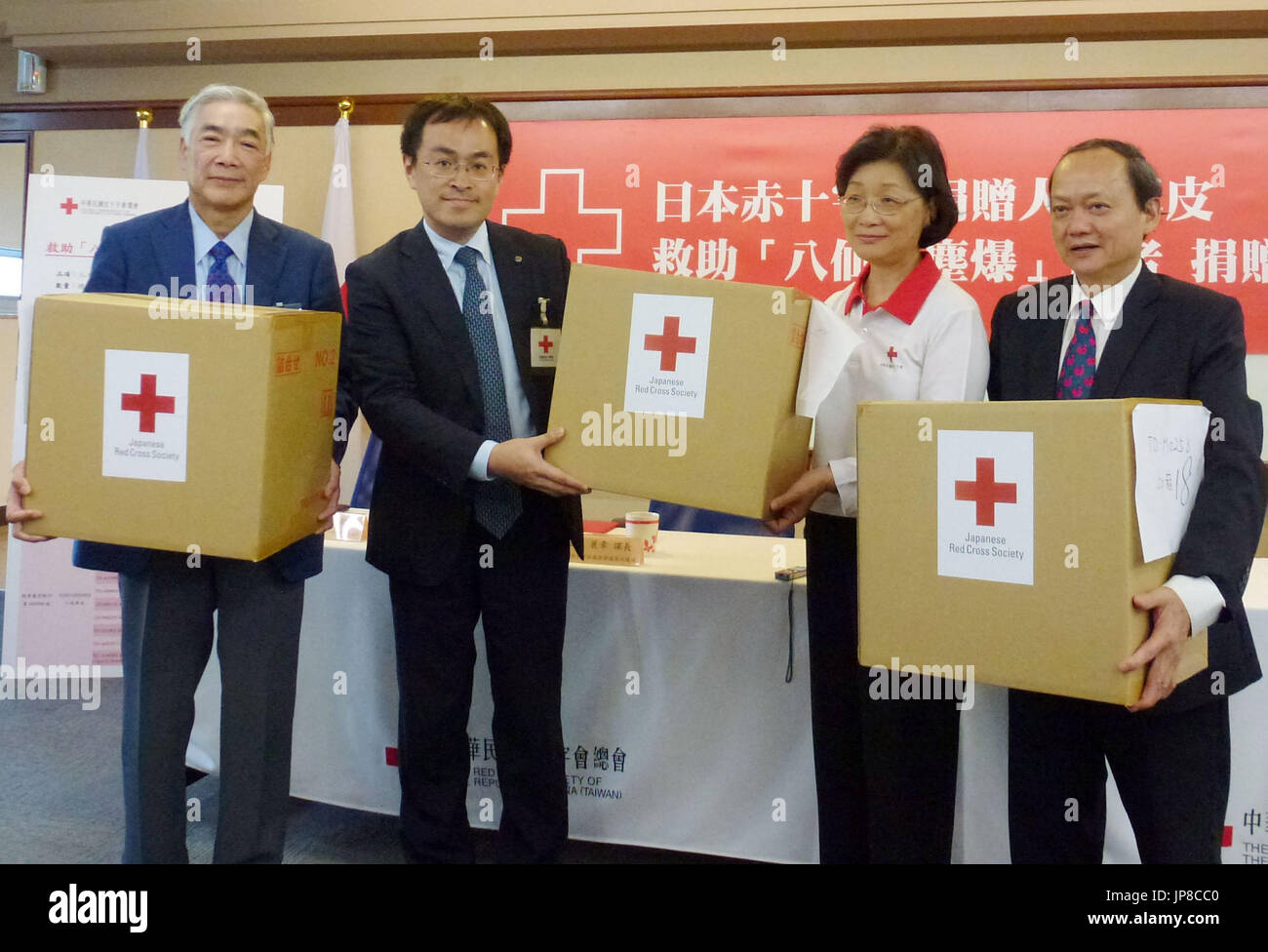 Officials of the Japanese Red Cross Society (two on L) present a ...