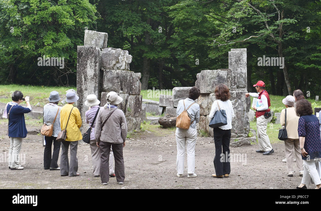 Tourists visit the ruins of the Hashino iron mining and smelting site ...