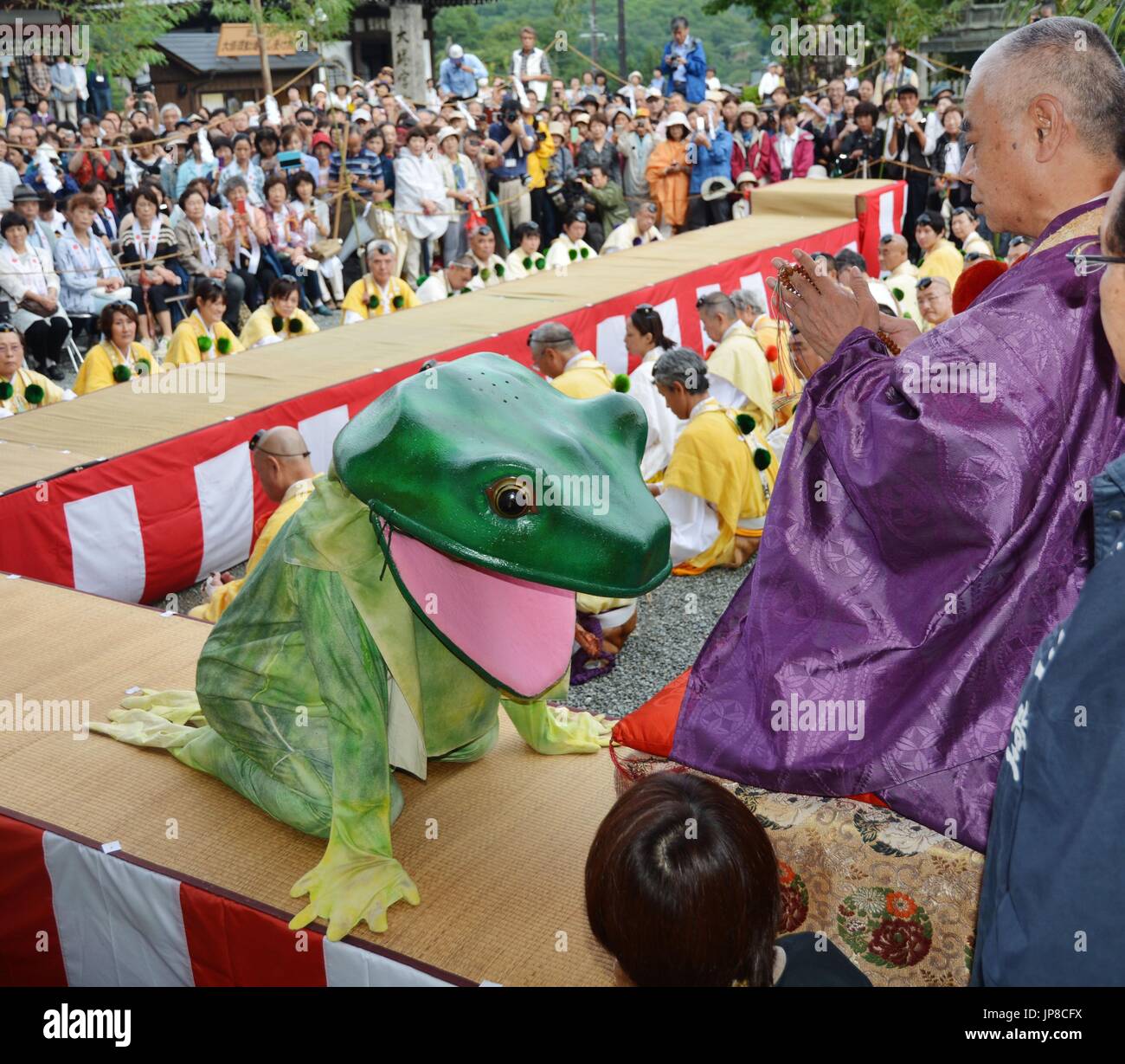 A man clad in a frog costume performs in a traditional "jumping frog ...