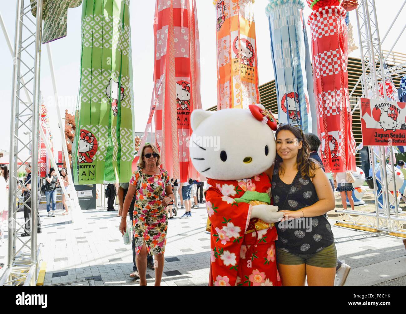 A woman poses with Hello Kitty for a photo at the Japan Pavilion at the ...
