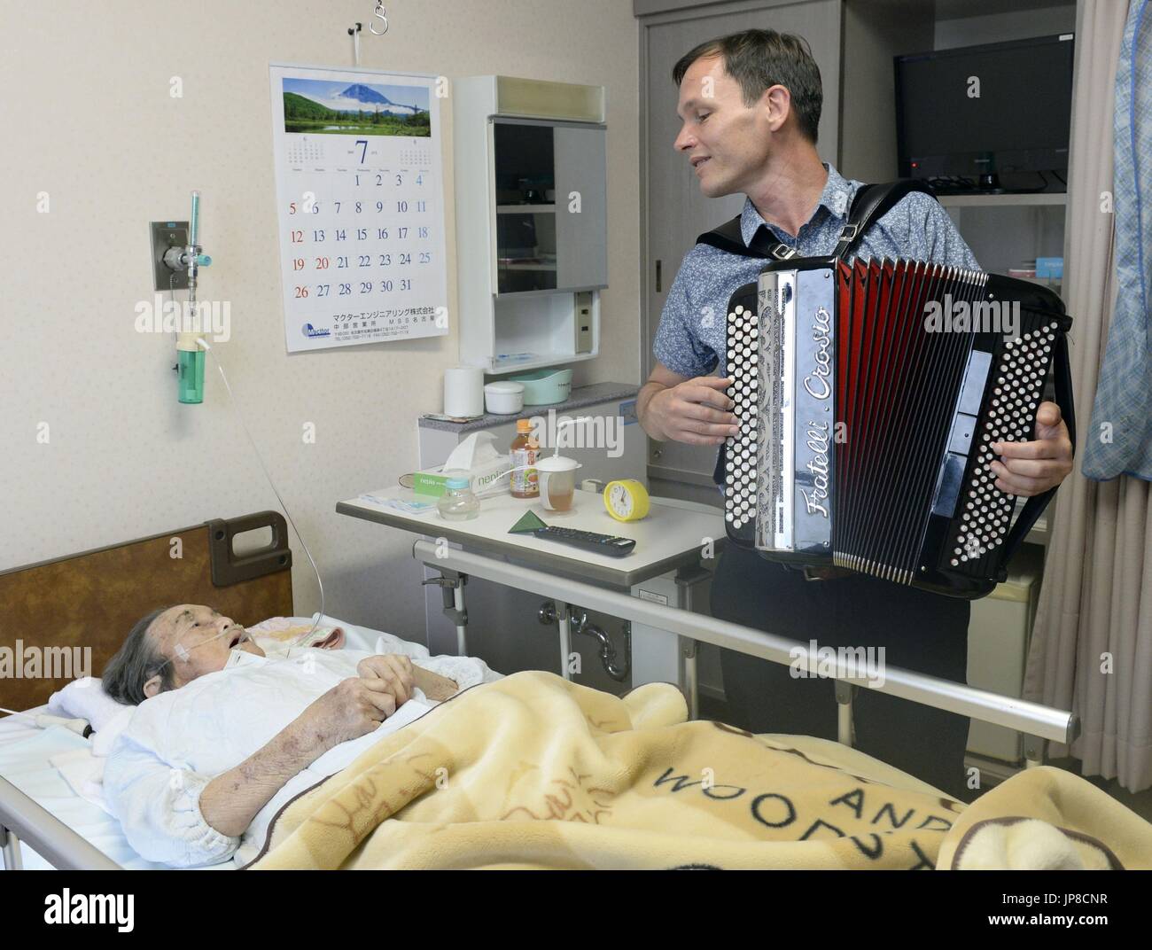 French professional accordion player Michel Glasko (R) performs for a ...