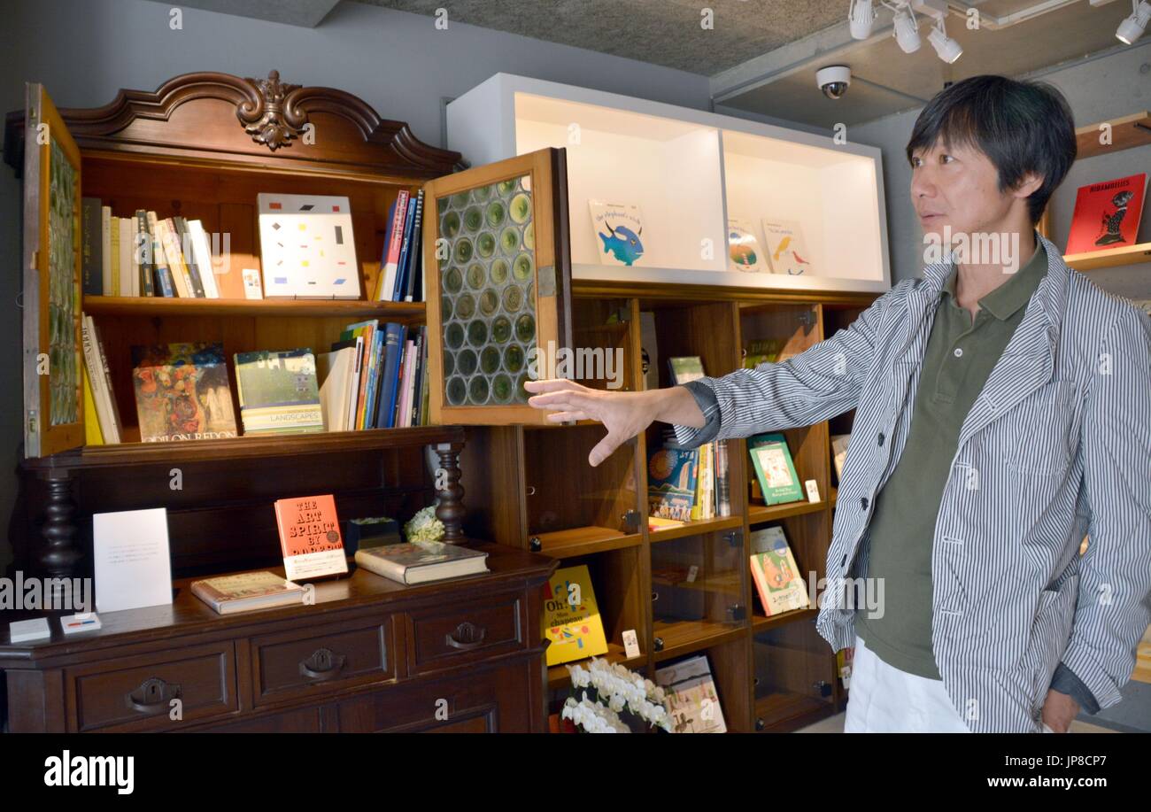 Owner Katsuo Mizuguchi explains on June 14, 2015, about his new shop ...