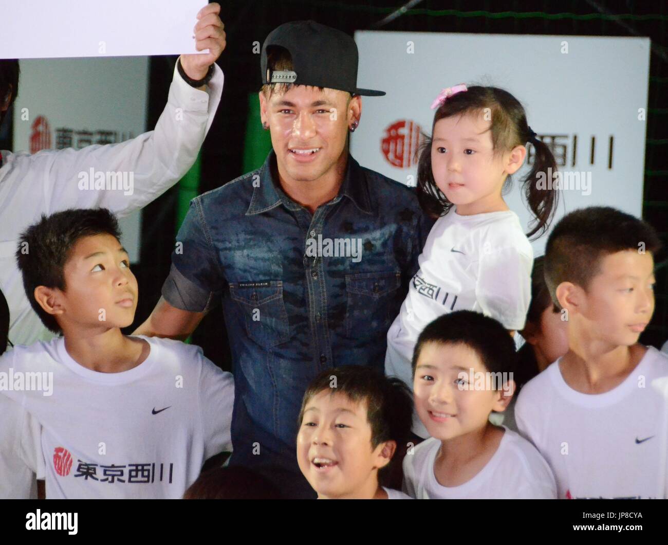 Brazil and FC Barcelona striker Neymar poses for photos with children ...