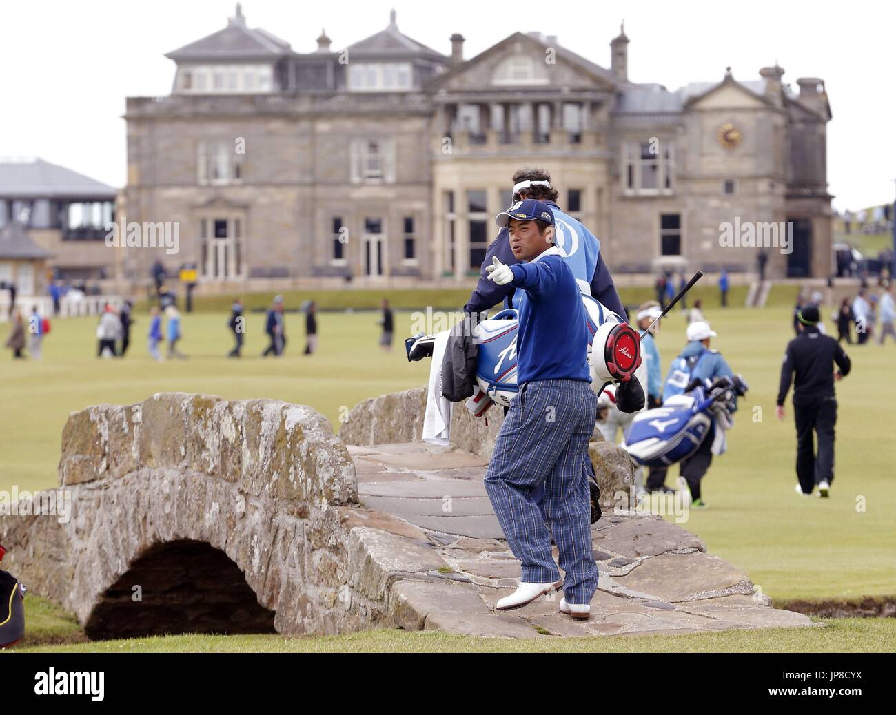 Japanese golfer Yuta Ikeda crosses the famous Swilcan Bridge during a ...