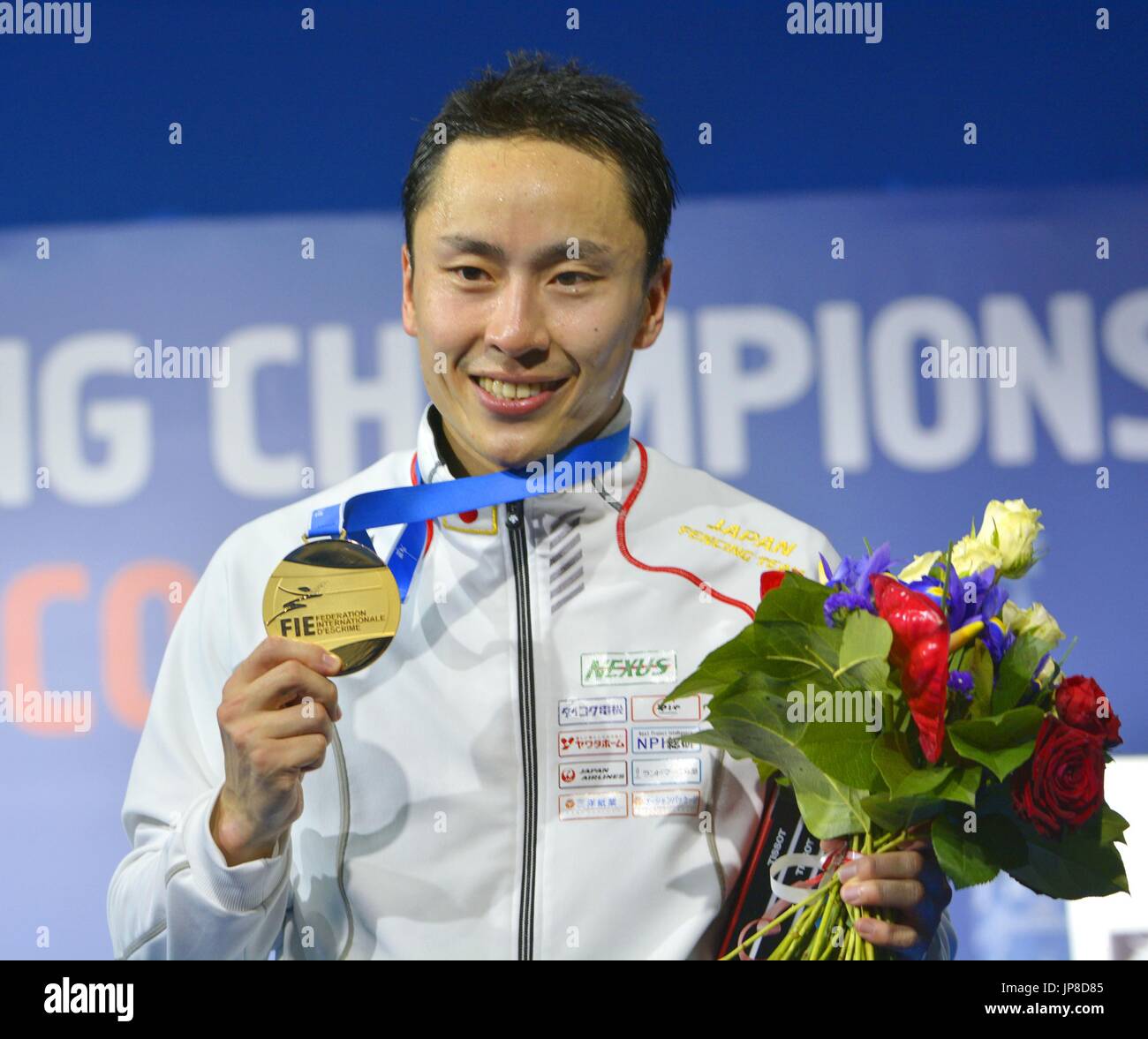 Japanese fencer Yuki Ota poses for photos with his gold medal after winning the men's foil event ...