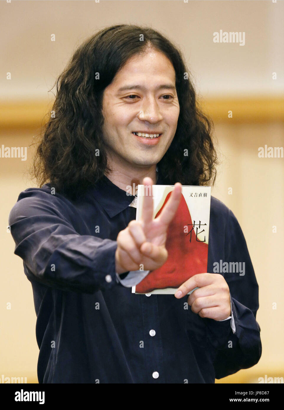 Comedian Naoki Matayoshi throws up a deuce in Tokyo on July 16, 2015 ...