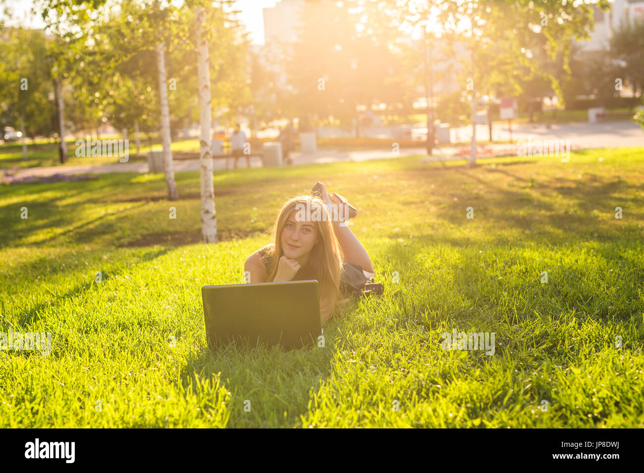 Young girl with laptop working outdoor Stock Photo - Alamy