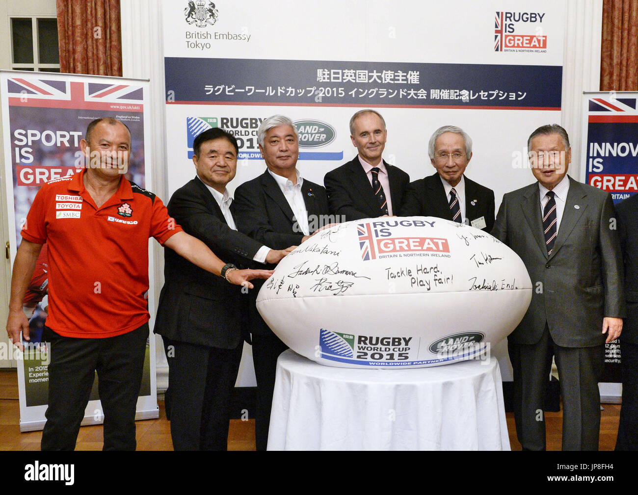 Japan's national rugby team coach Eddie Jones (far L) poses for photos ...