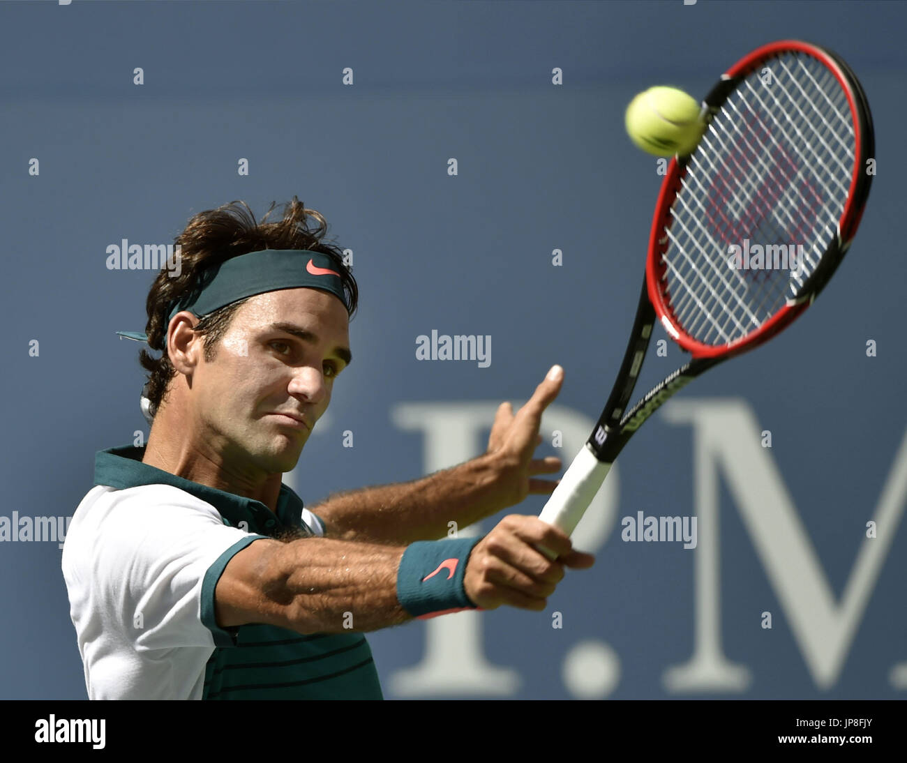 Roger Federer of Switzerland returns a shot during his third round U.S ...