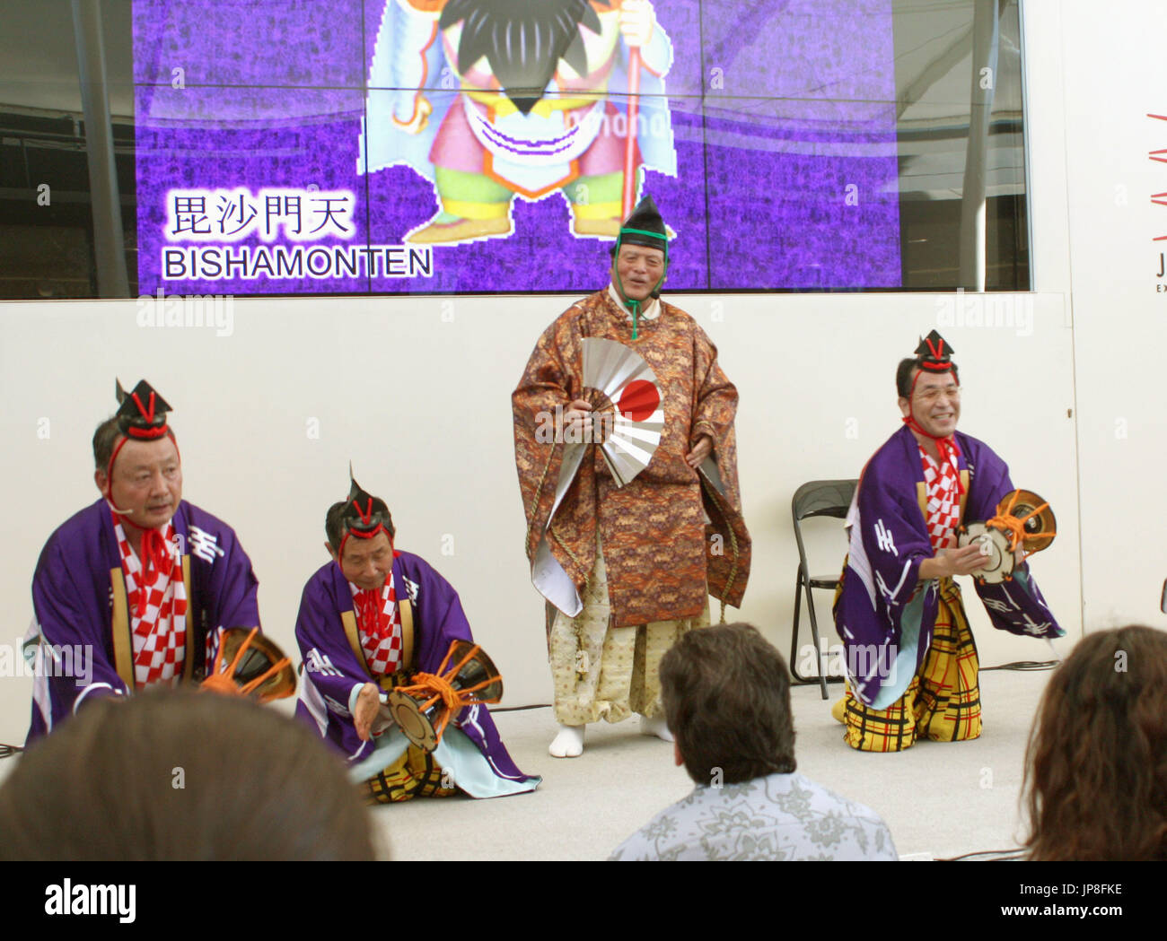 Japanese men clad in traditional Shinto priest costumes perform the ...