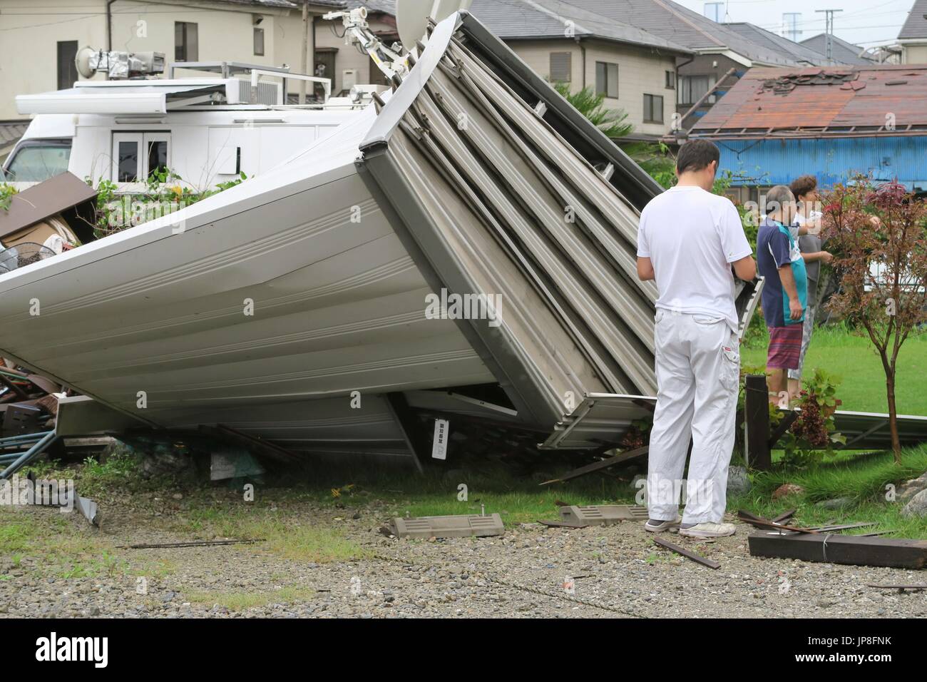 A storage shed has been turned over and badly damaged due to severe ...