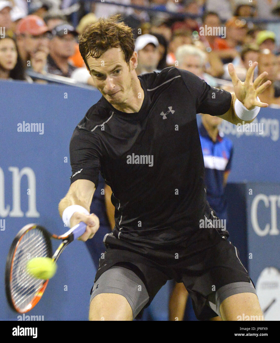 Andy Murray of Britain returns a shot during his fourth-round match ...