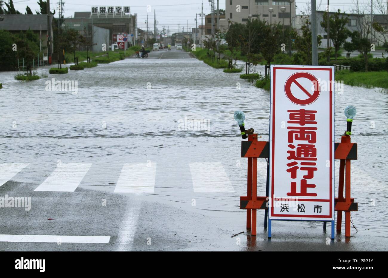 A water-covered road in the central Japanese city of Hamamatsu is ...