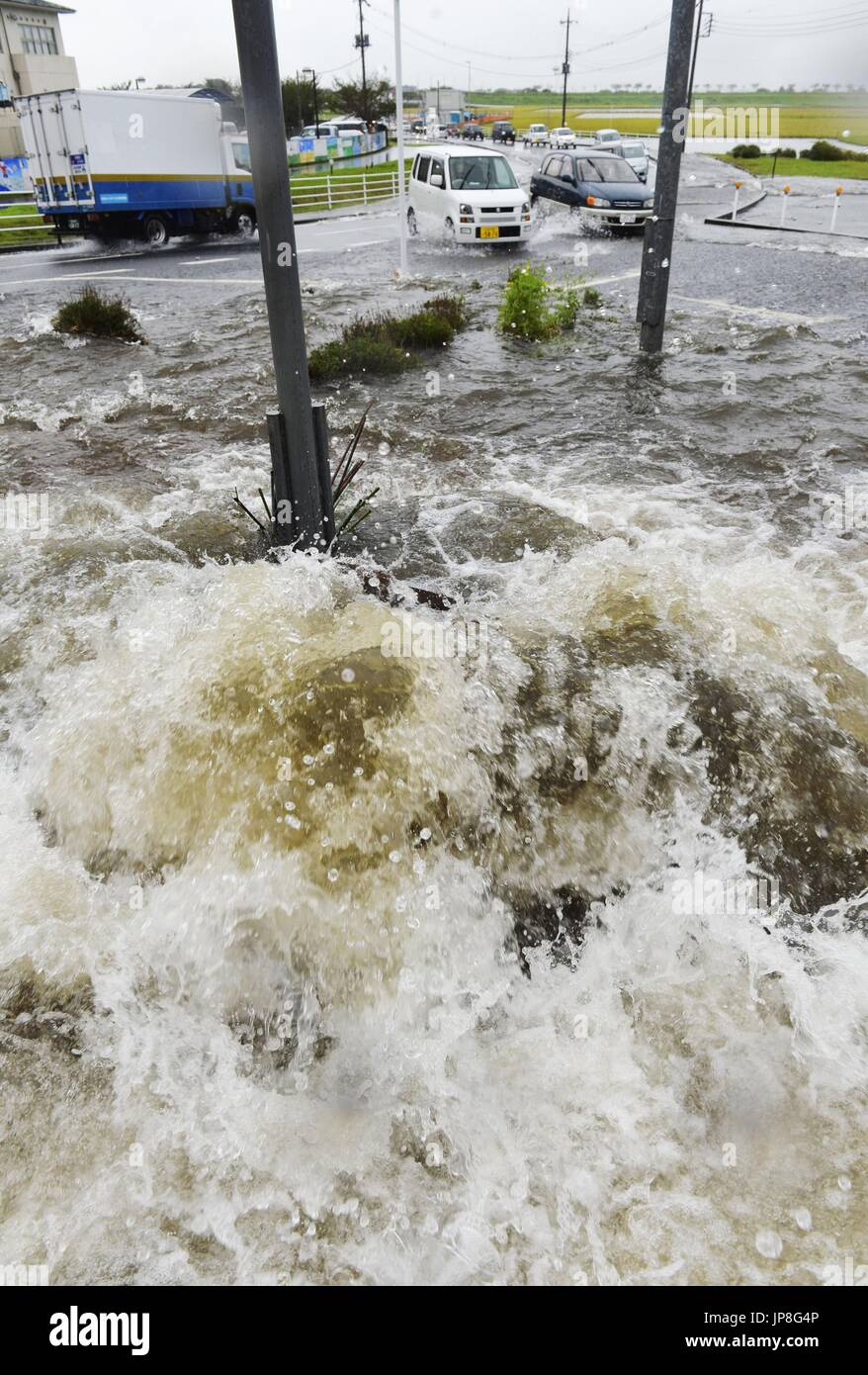 Water spurts out of a manhole near a road in Oyama, Tochigi Prefecture ...