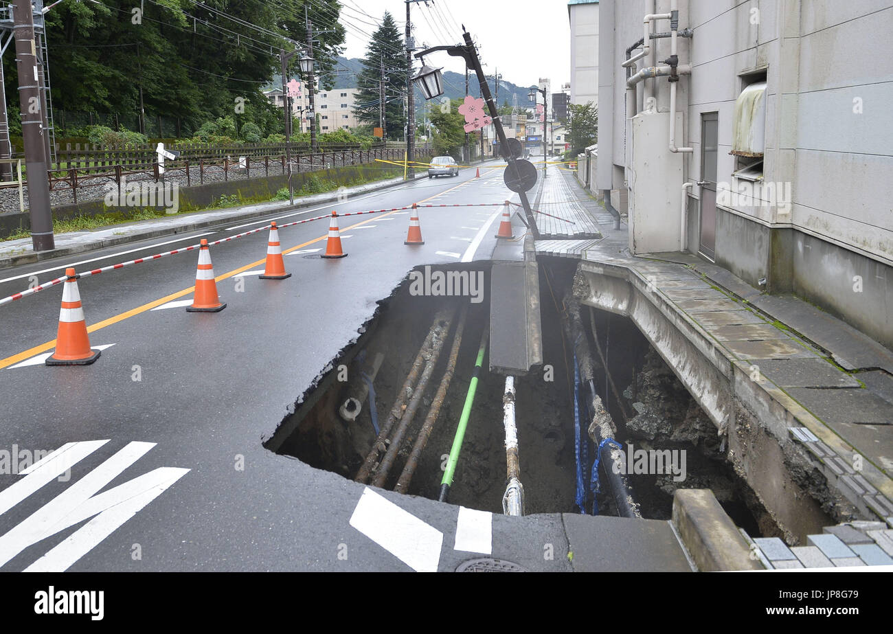 A road caves in due to torrential rains in Nikko, Tochigi Prefecture ...
