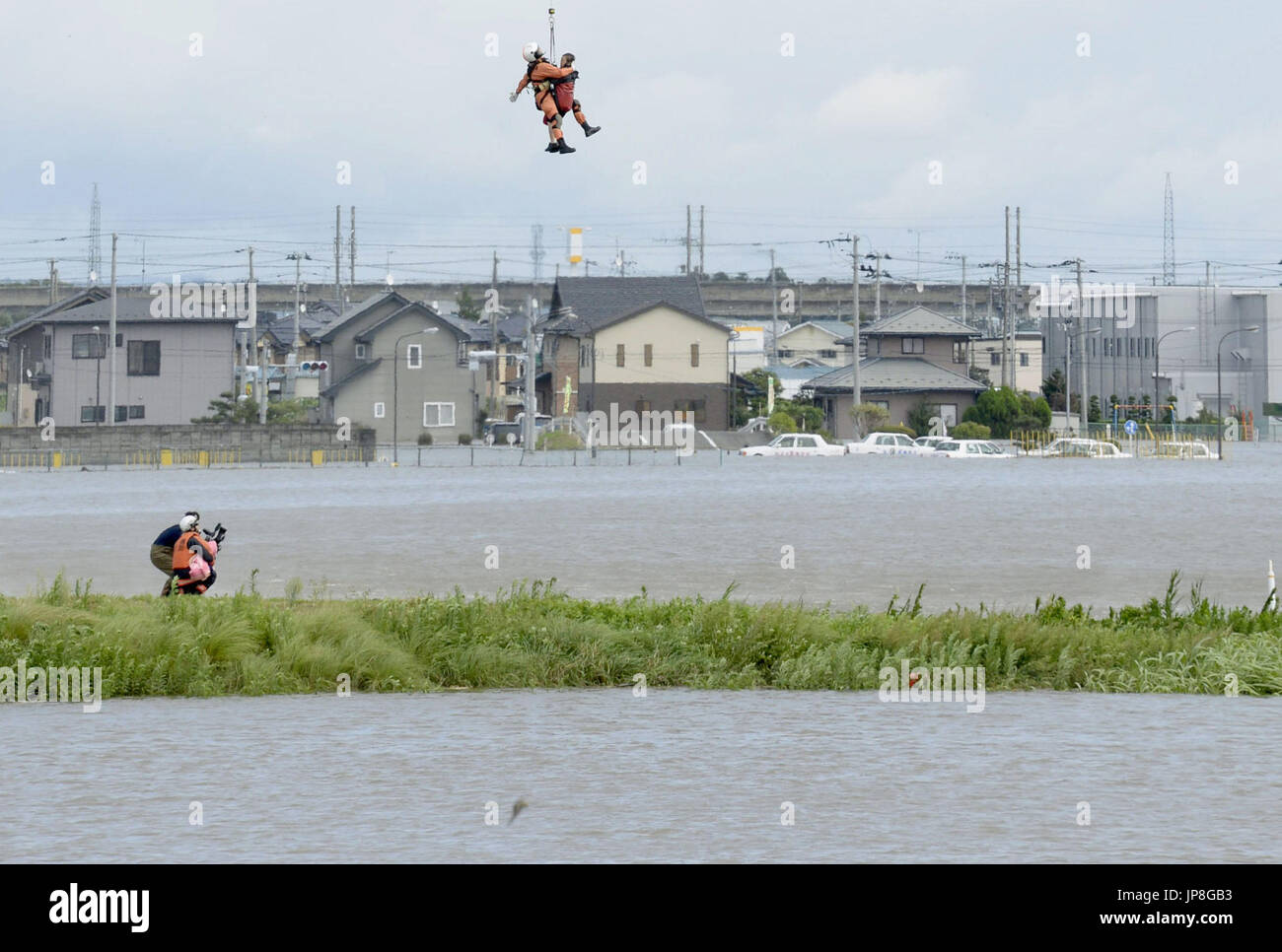 A person is rescued by helicopter from a flooded area in the ...