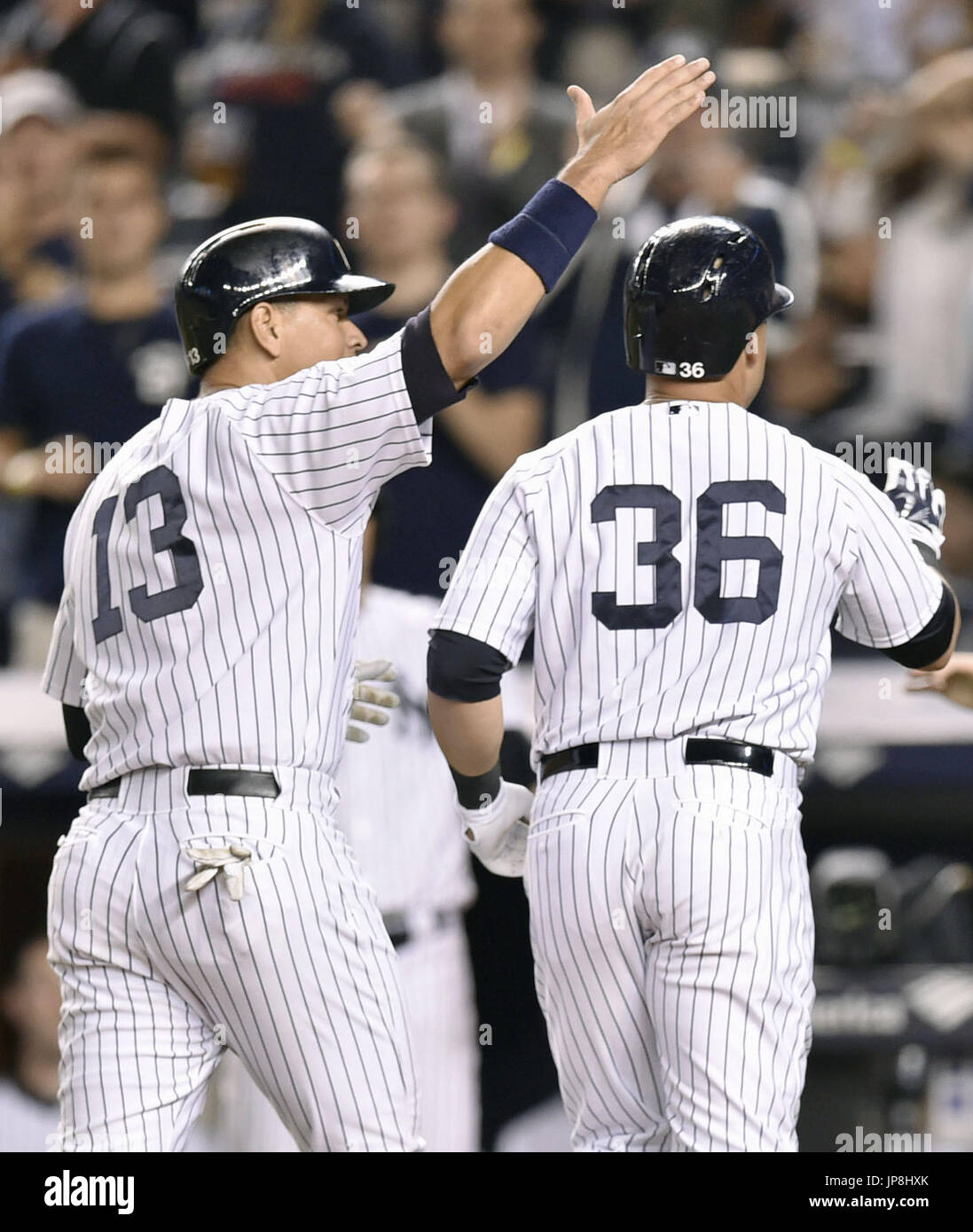 Alex Rodriguez (L) of the New York Yankees raises his right arm in ...