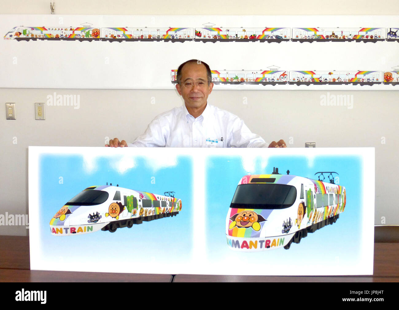 Masafumi Izumi, president of Shikoku Railway Co., shows images of an ...