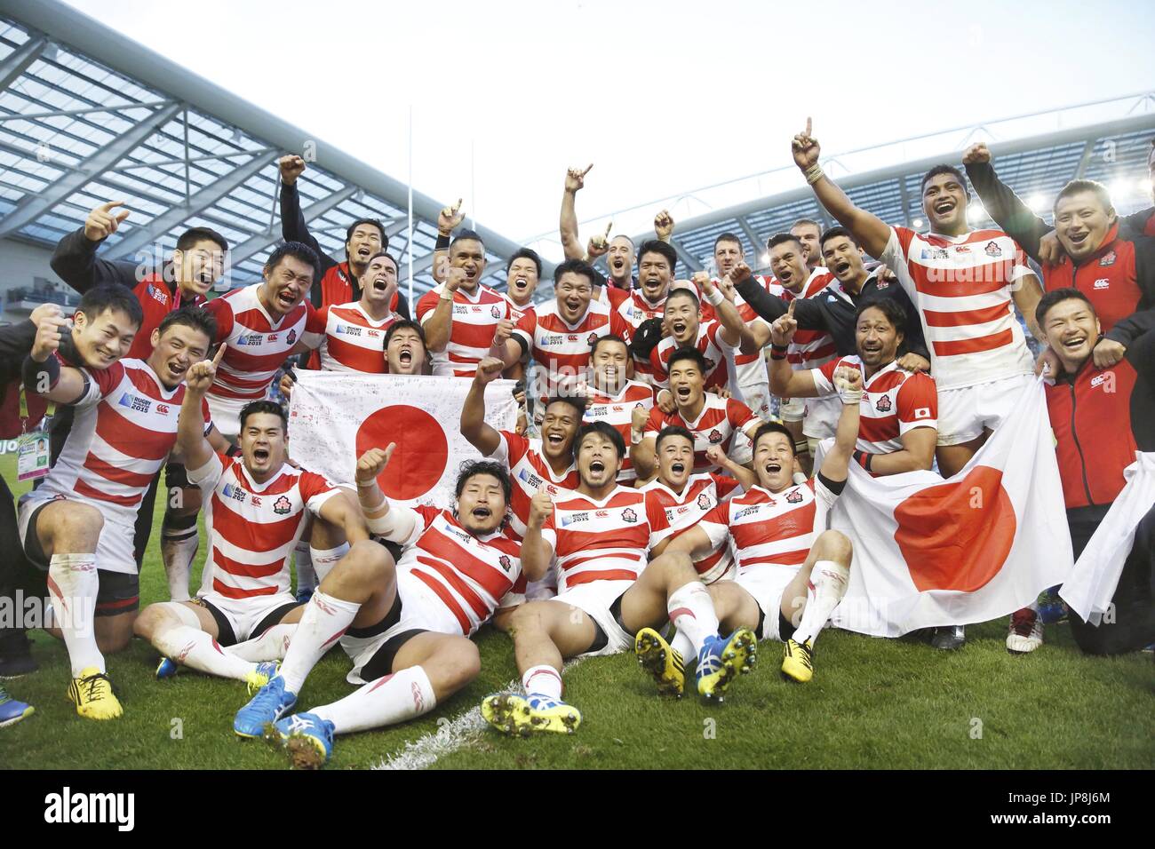 Japan players pose for a photo after beating South Africa 34-32 in a ...