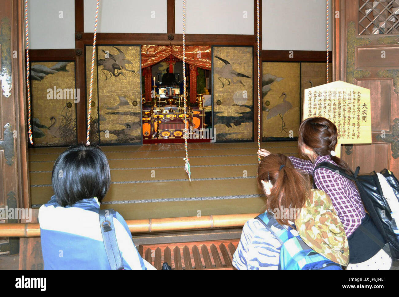 Visitors offer prayers in front of a statue of Buddhist monk Kukai ...
