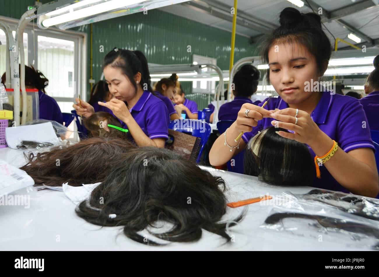 Employees work at Japanese wig maker Aderans Co.'s factory in ...
