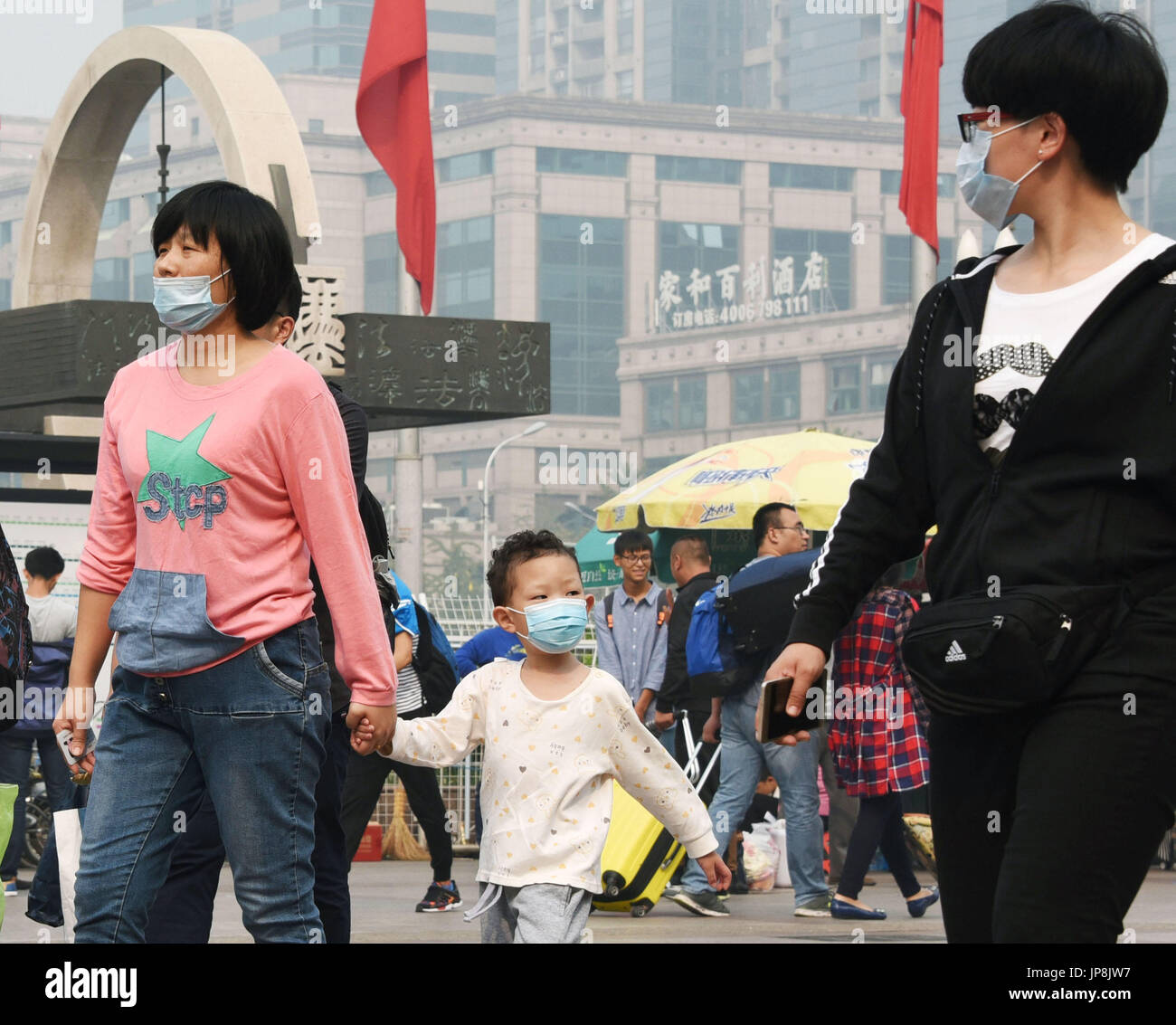 People wear masks on the streets of Beijing due to severe air pollution ...