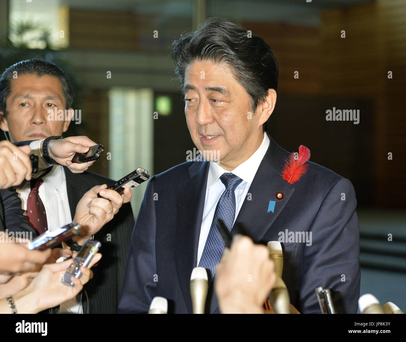 Japanese Prime Minister Shinzo Abe meets with reporters at his office ...