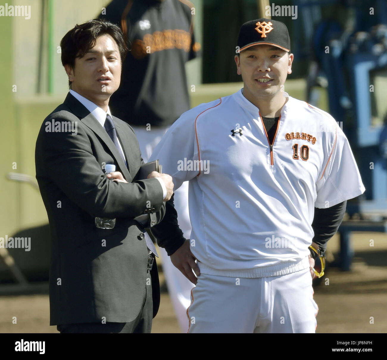 New Yomiuri Giants manager Yoshinobu Takahashi (L) talks with the team ...