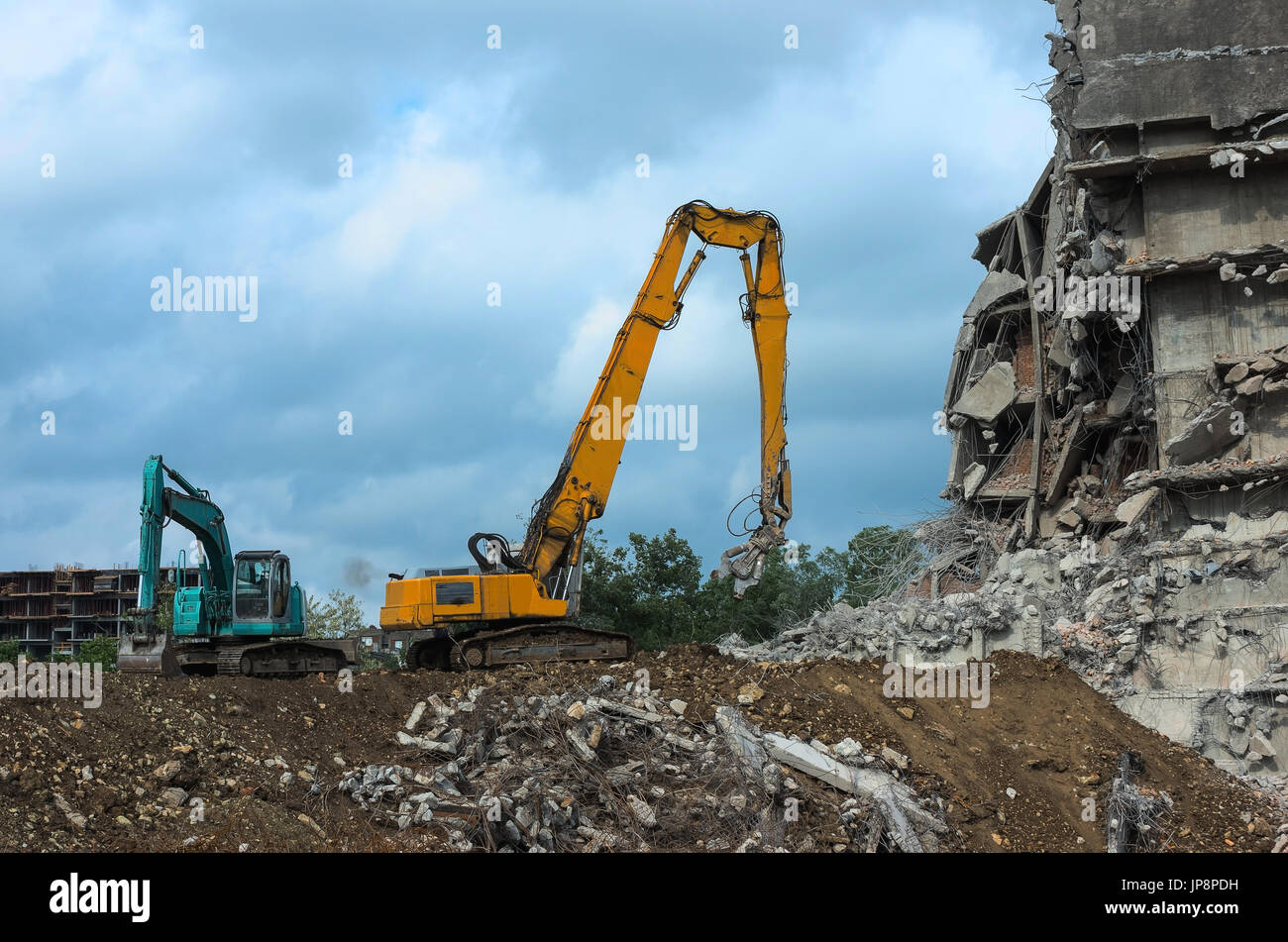 Heavy equipment being used to tear tearing down building construction ...